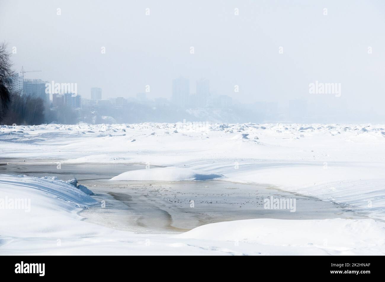 Stunning view of the frozen river covered with chunks of ice and white ...
