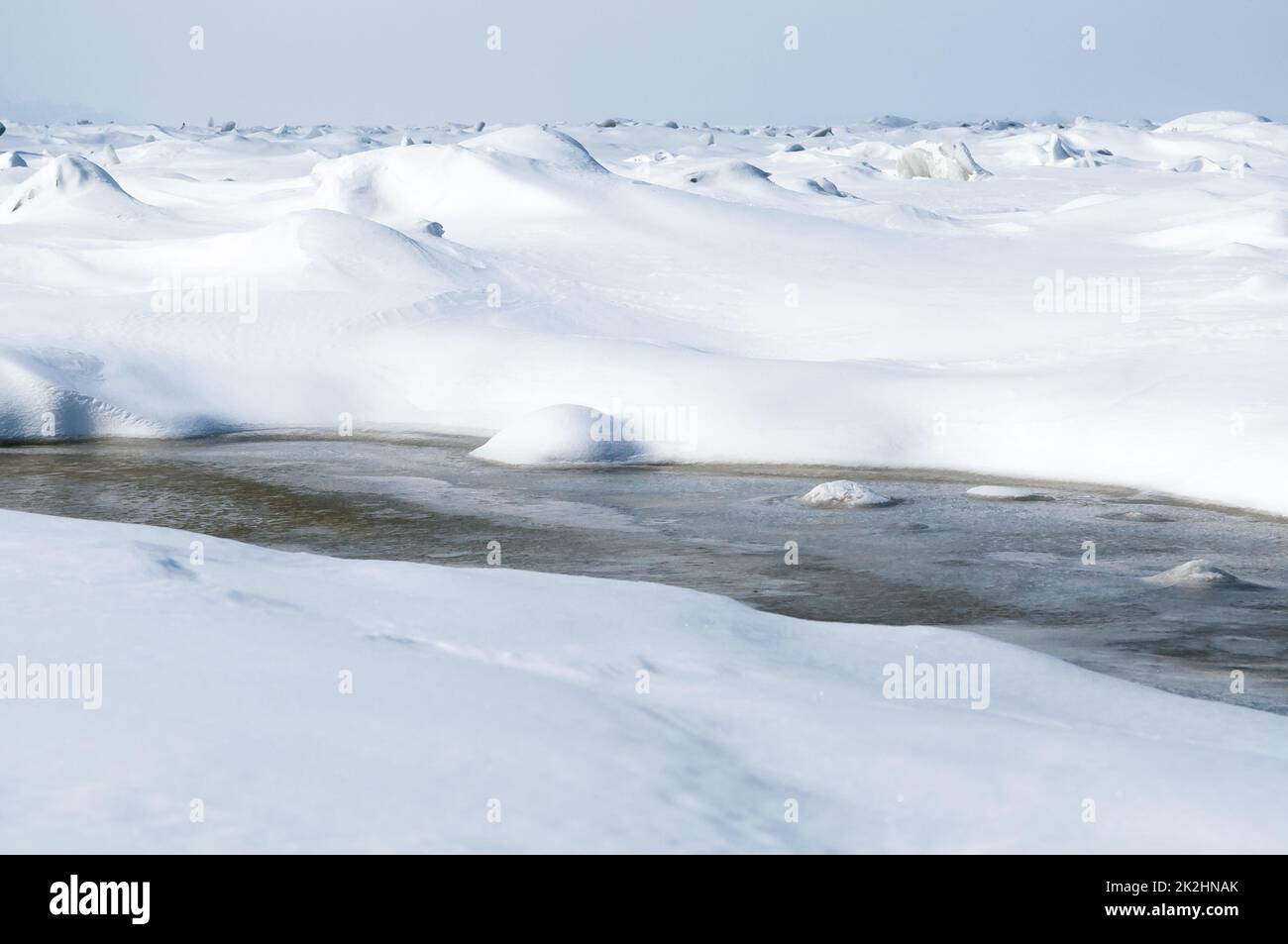 Stunning view of the frozen river covered with chunks of ice and white ...