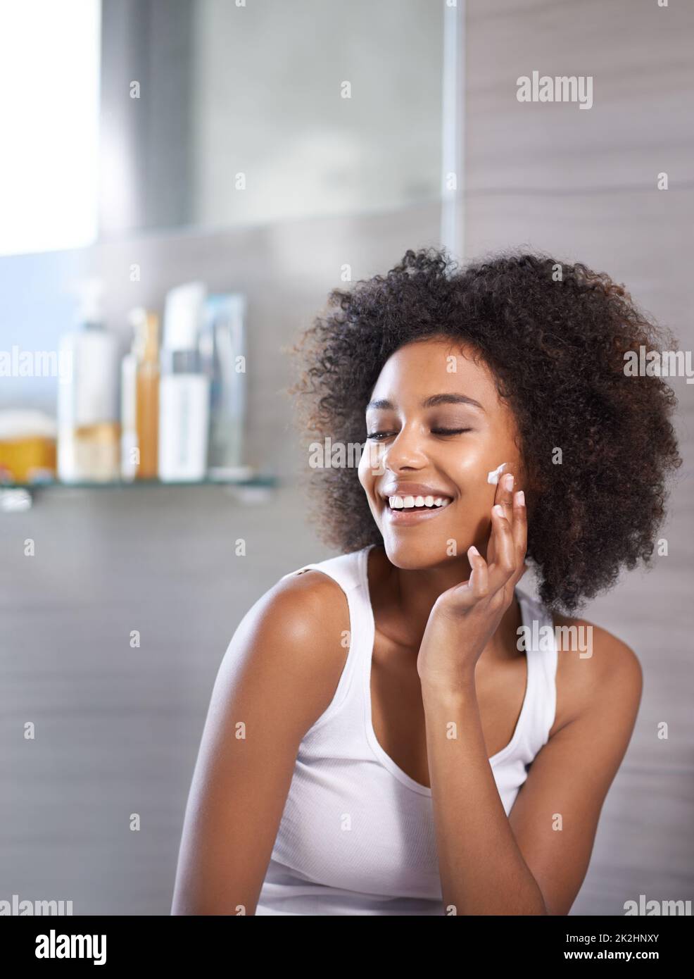 Taking Care Of My Skin An Attractive Young Woman Applying Cream To Her