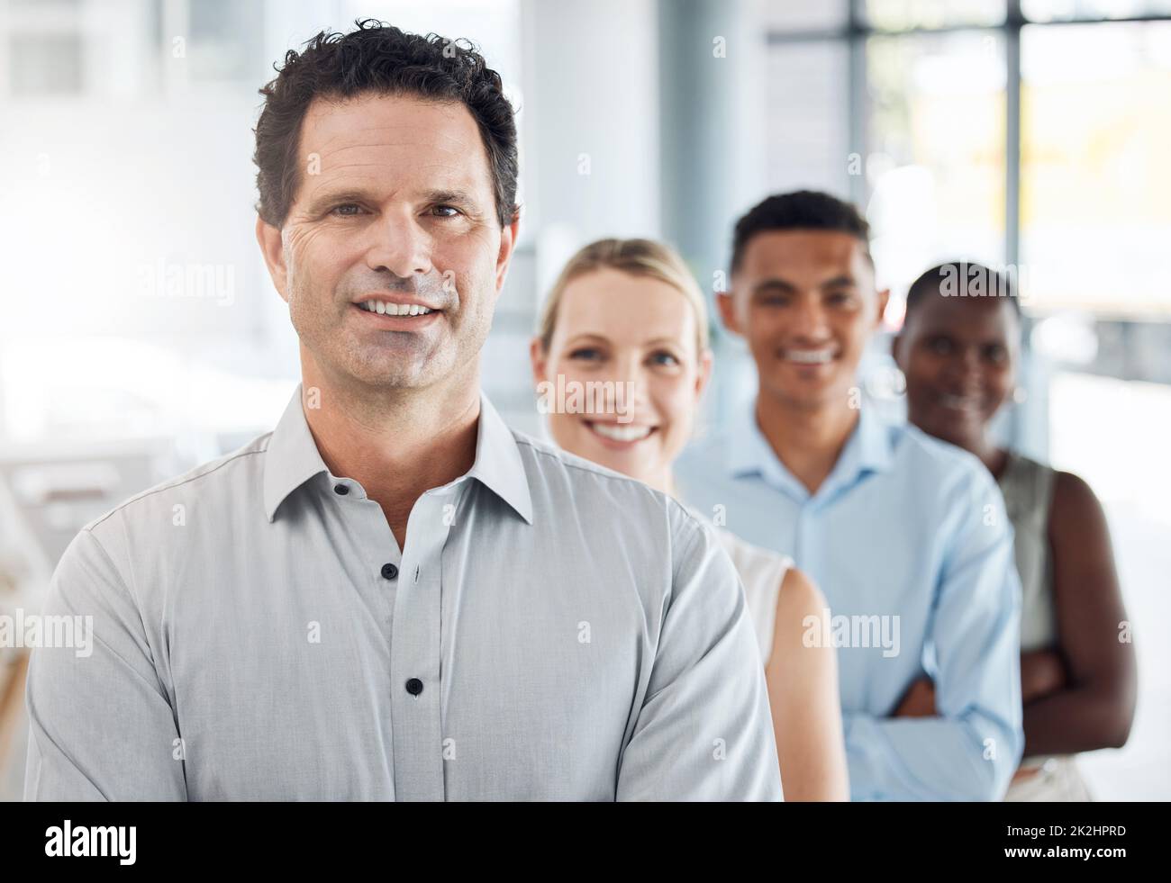 Portrait of a corporate manager and his team in a modern office after ...