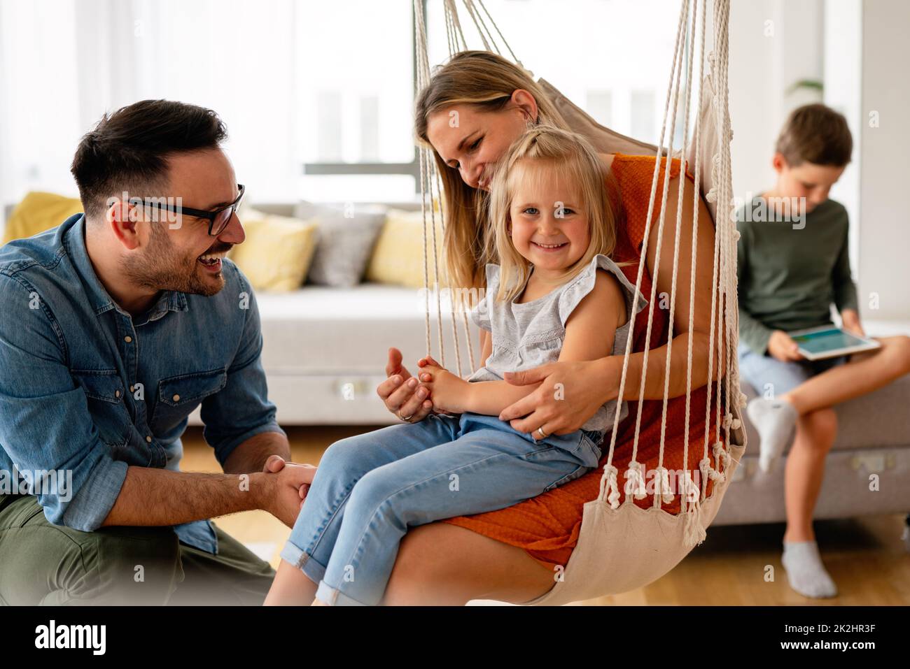 Happy family having fun time at home. Parents playing smiling with ...