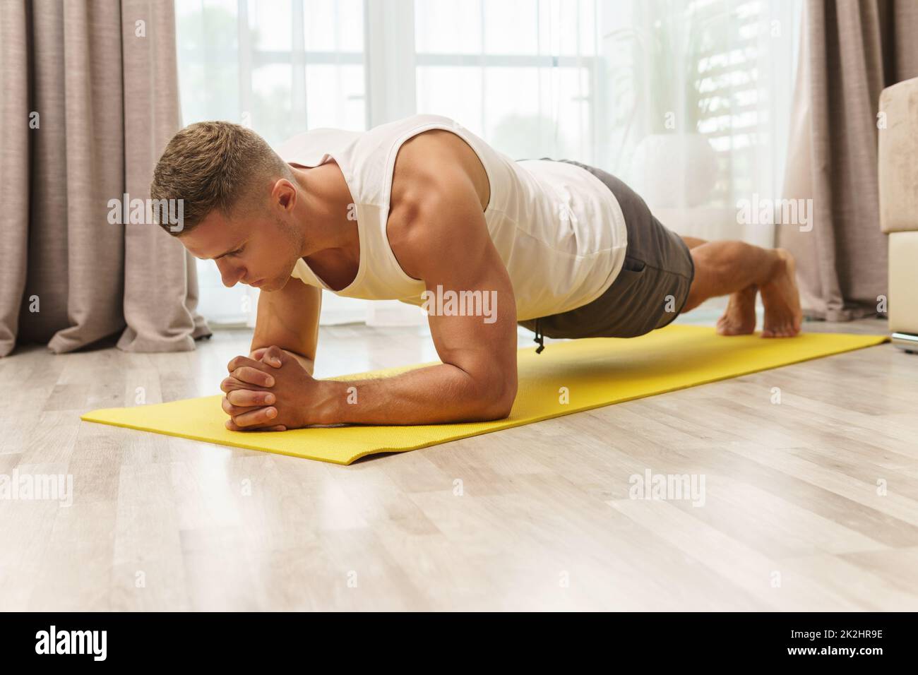 Man doing plank during intense home workout Stock Photo - Alamy