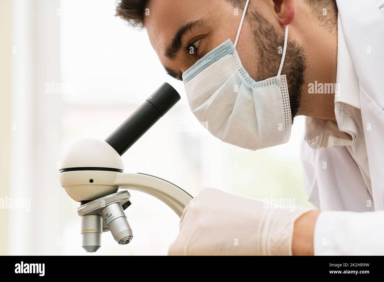 Scientist is using microscope in a laboratory during research Stock ...