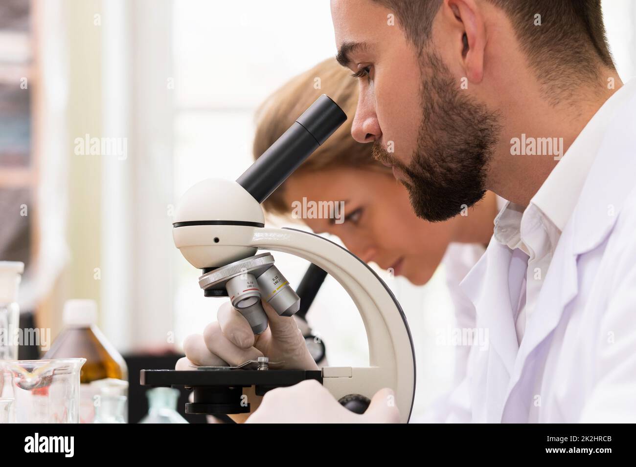 Two scientist colleagues are using microscopes during research in a laboratory Stock Photo - Alamy