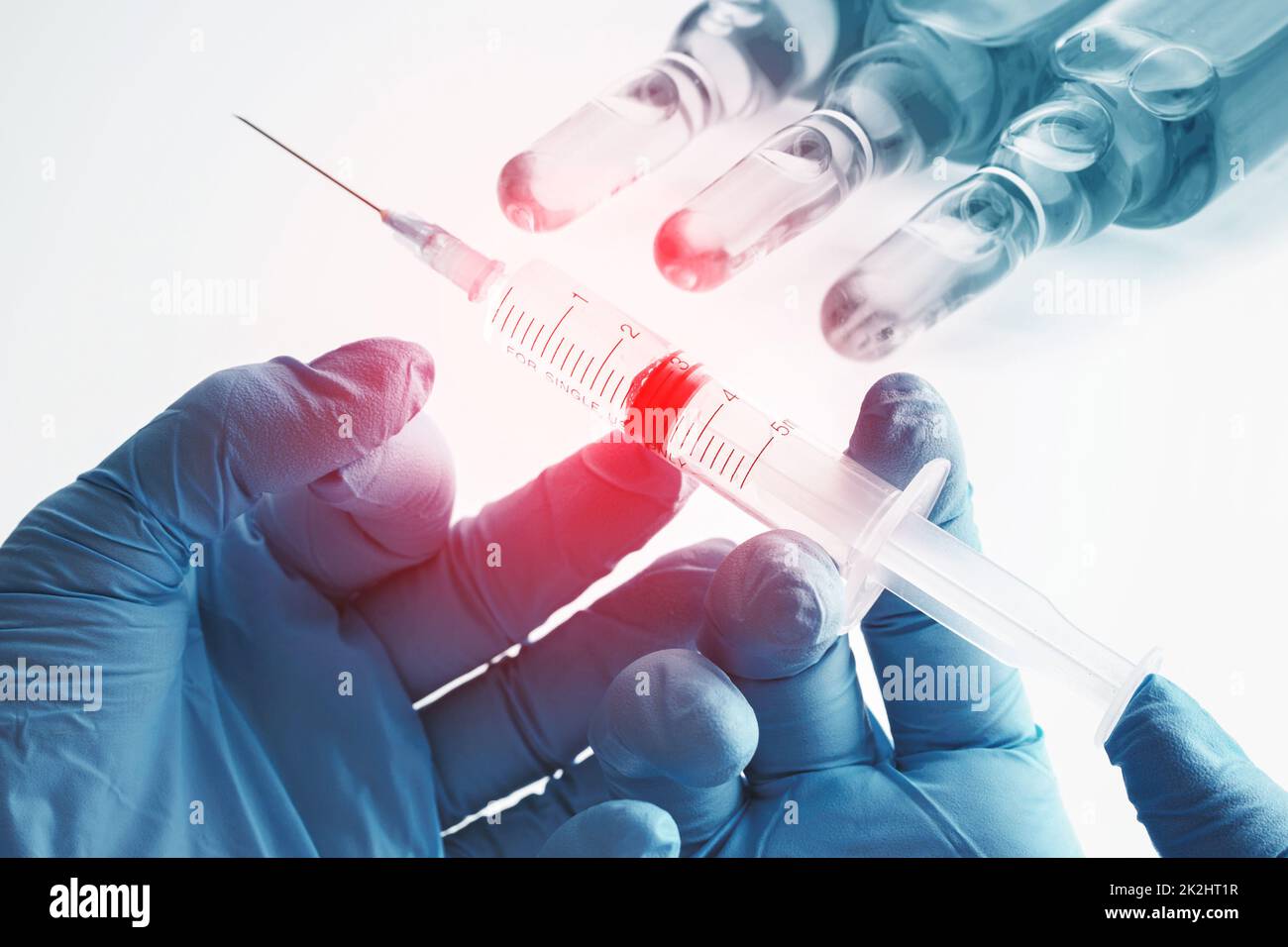Doctor's hands holding syringe with a vaccine, medical remedy or ...