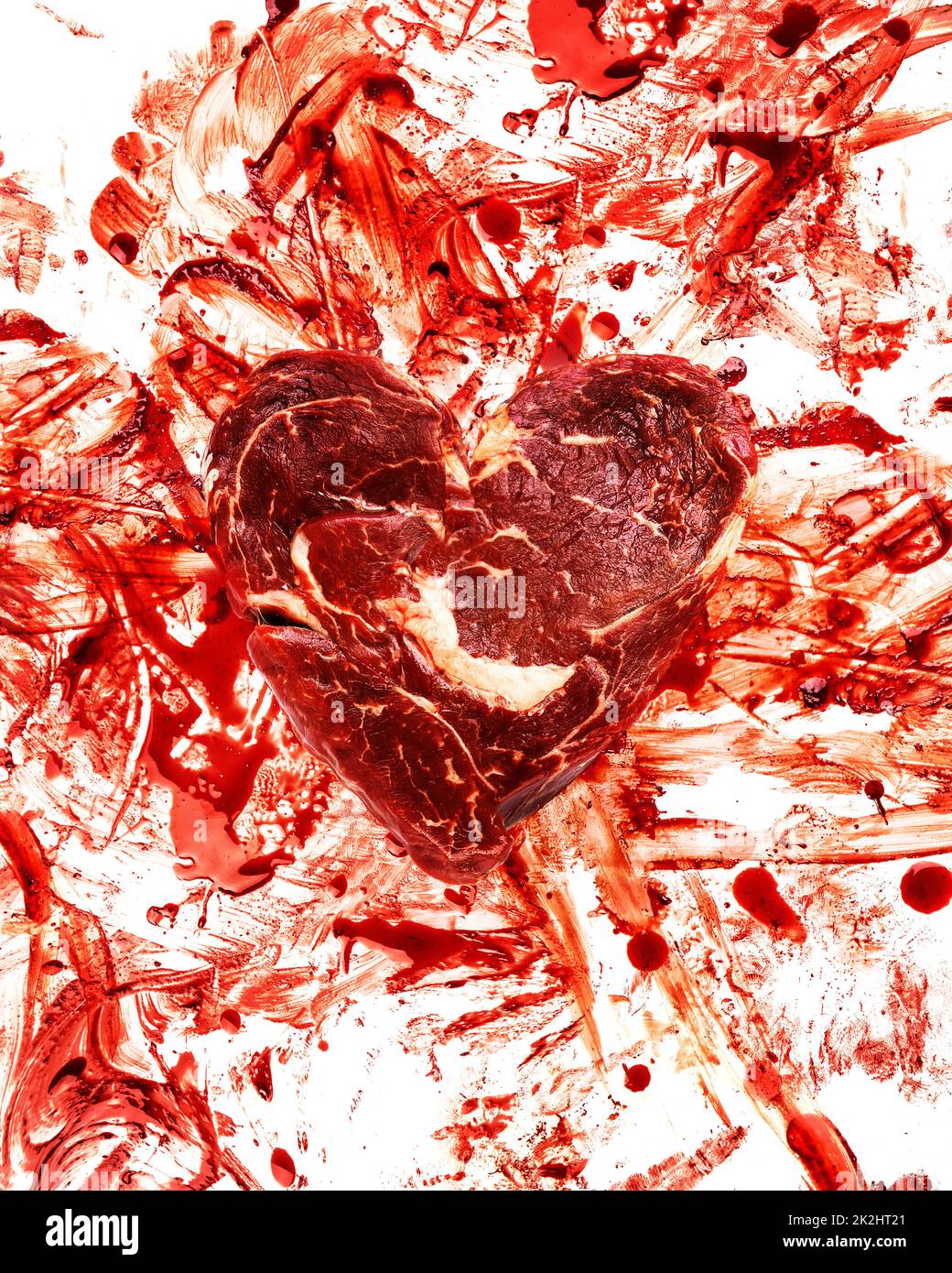 Fresh raw meat in shape of heart and blood splatters Stock Photo - Alamy