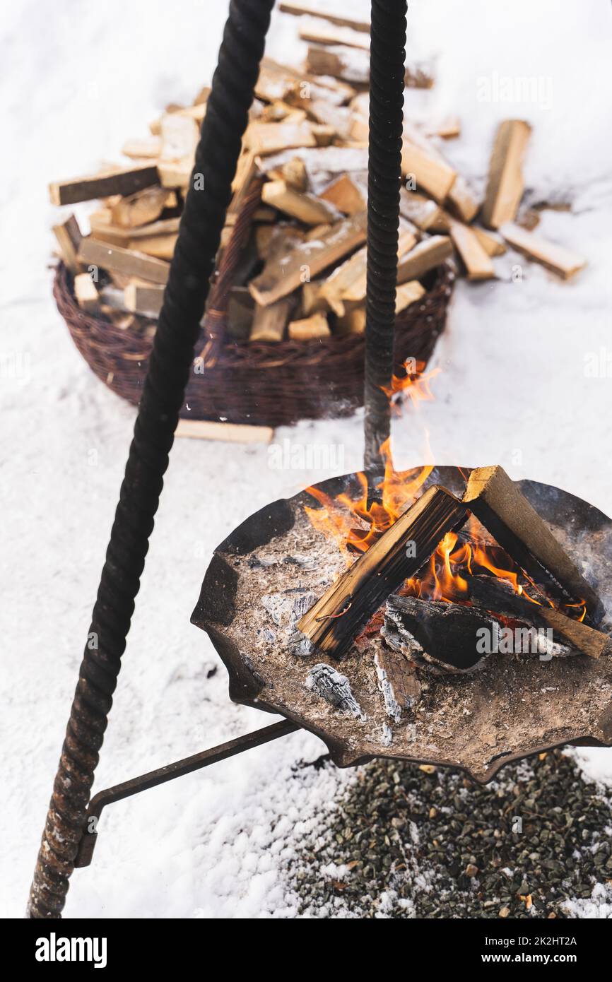 Firewood burning inside the fire-pit during cold winter day Stock Photo ...