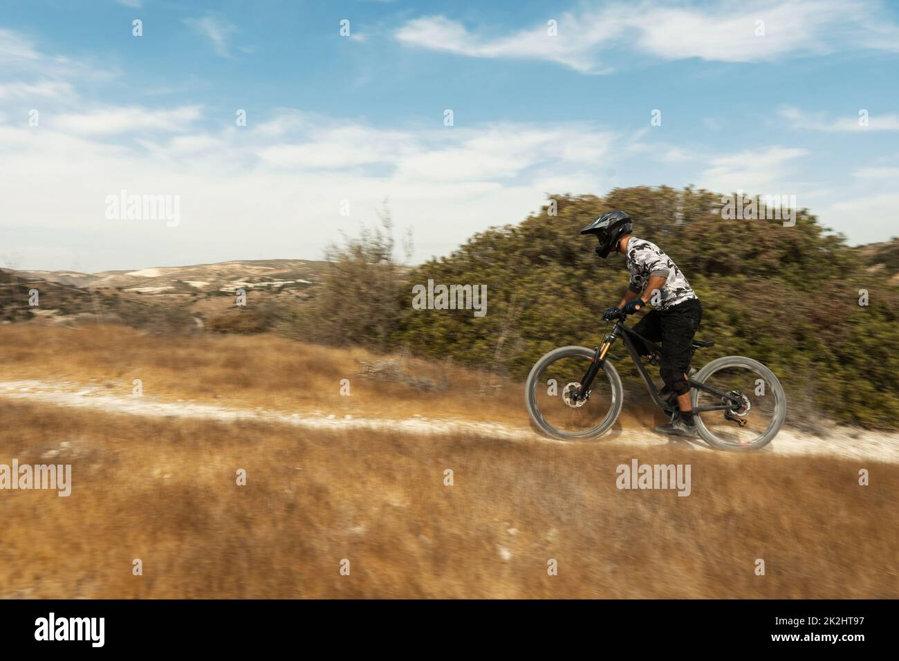 Professional bike rider during downhill ride on his bicycle in ...
