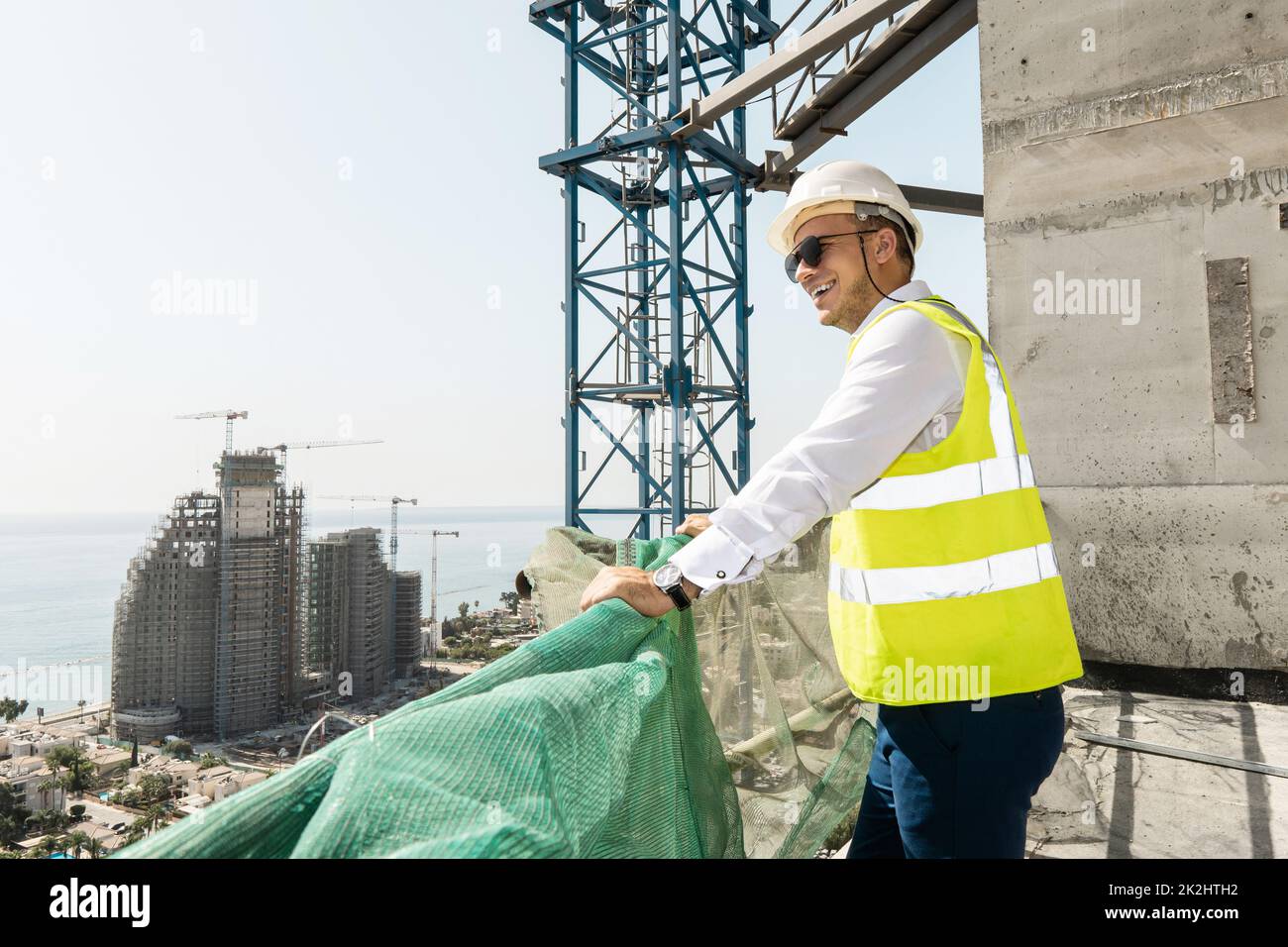 Successful engineer wearing reflective vest and hard hat on a ...