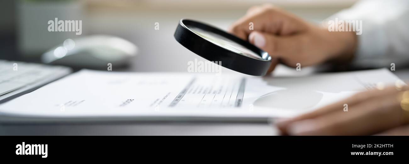 Auditor Doing Financial Audit And Tax Fraud Inspection Using Magnifying ...