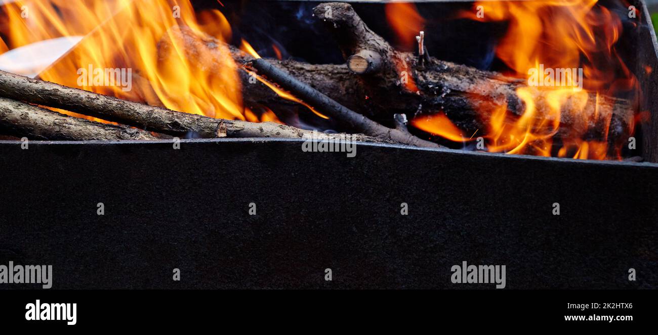 Burning red hot sparks fly from fire. Barbecue gril with glowing and ...