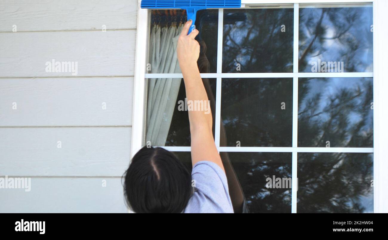 Female washing windows outdoors Stock Photo - Alamy