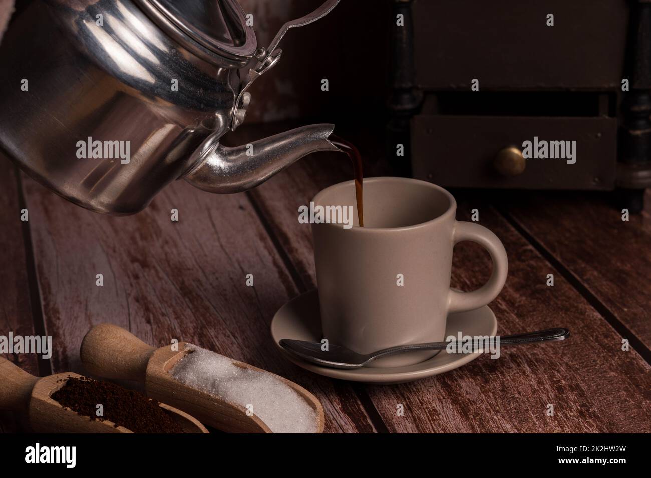 metal carafe pouring hot coffee in a cup Stock Photo - Alamy