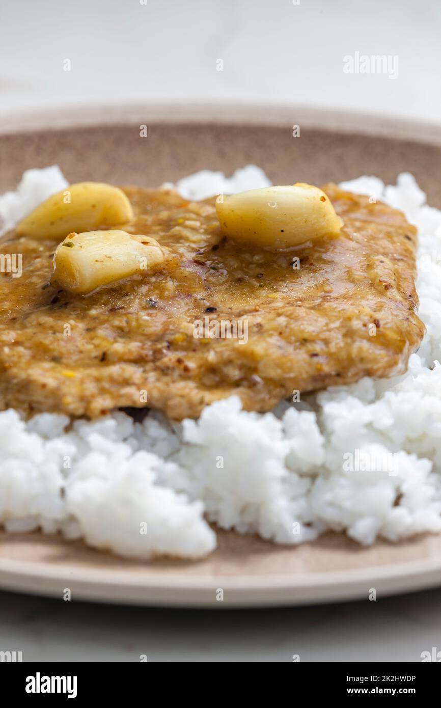 pork cutlet with garlic and rice Stock Photo - Alamy