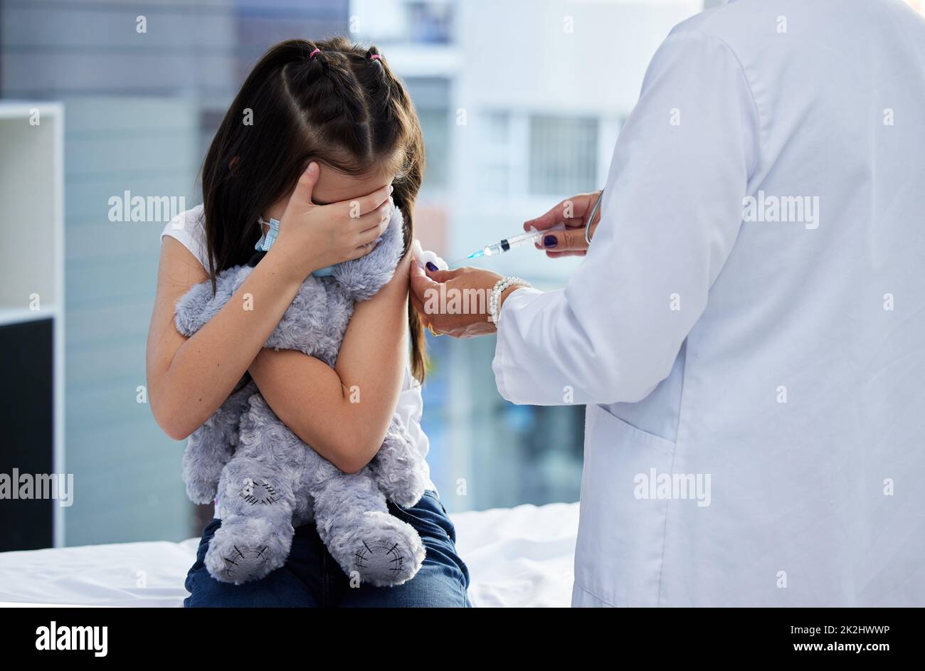 Is it done yet. Shot of a scared little girl getting a vaccination in a ...