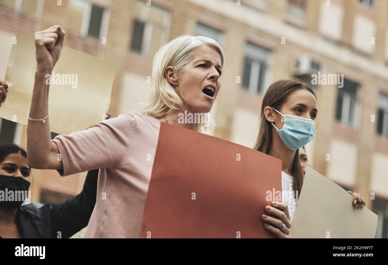 Fighting for what they believe in. Low angle shot of a group of people ...