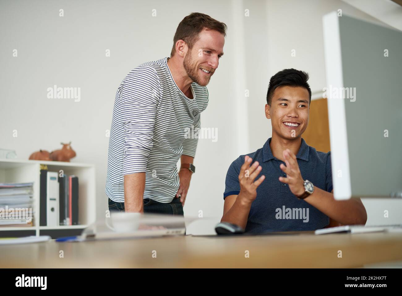 Two men working together on a project hi-res stock photography and ...