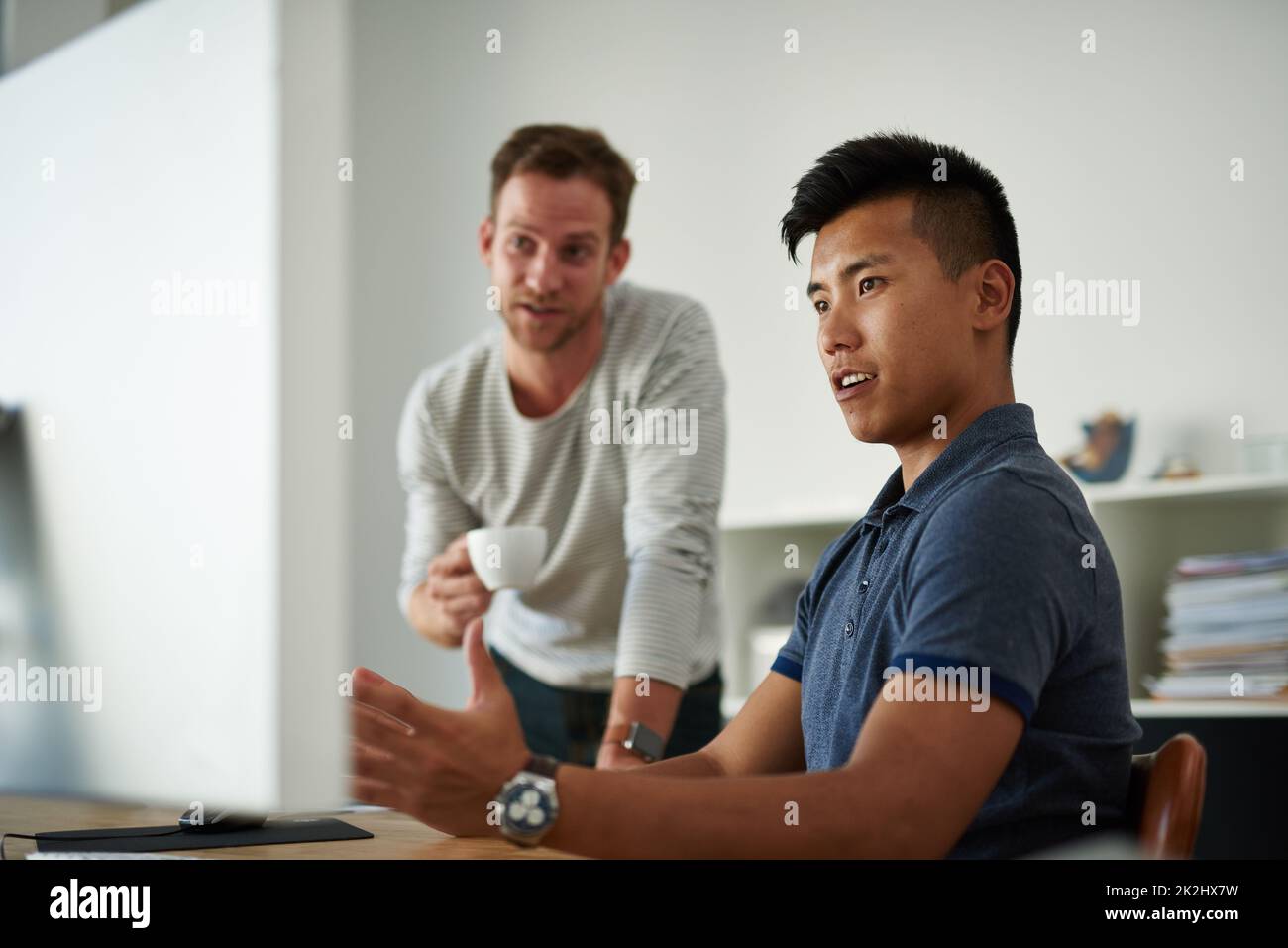Two men working together on a project hi-res stock photography and ...