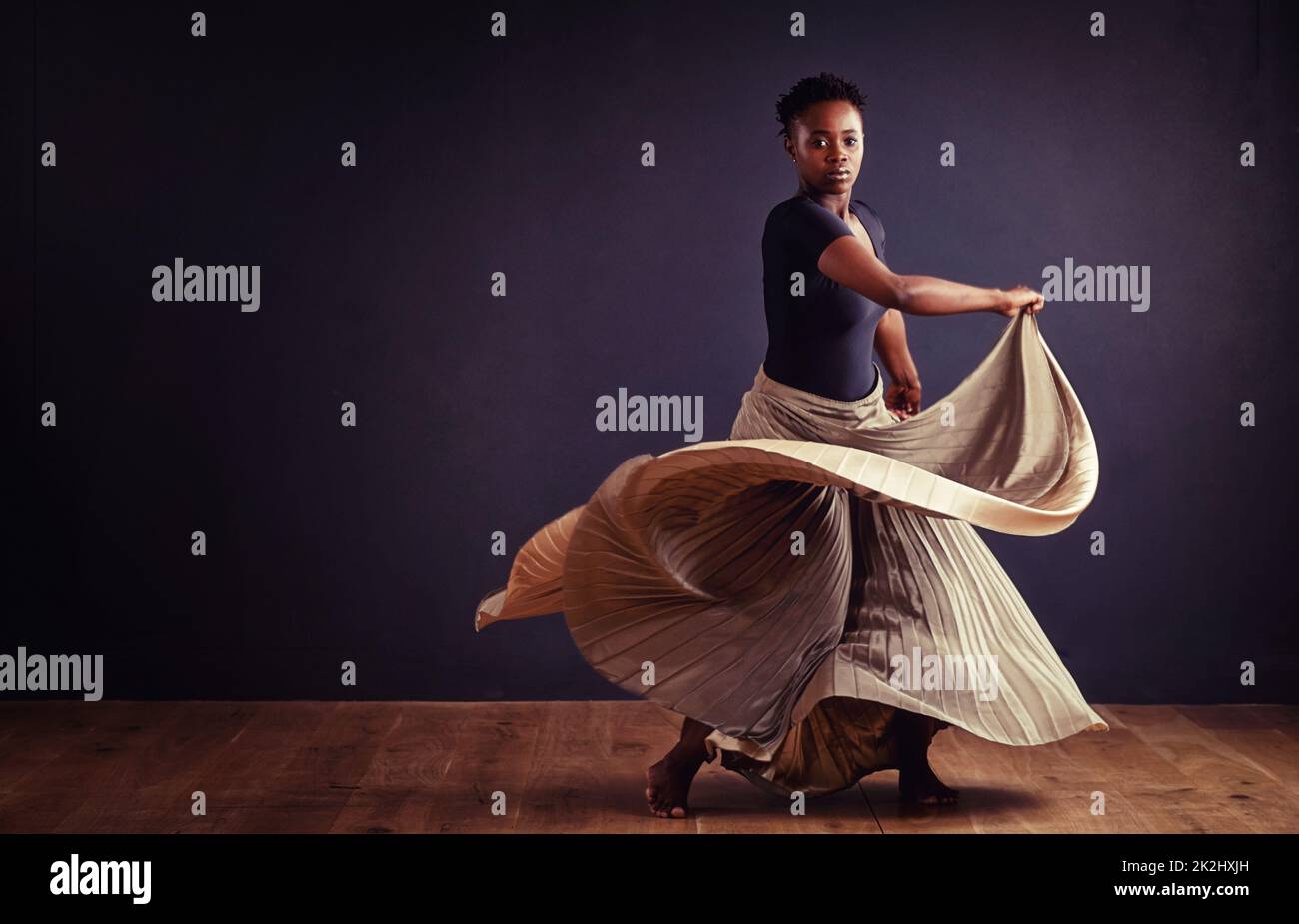 Feel the motion. Female contemporary dancer in a dramatic pose against ...