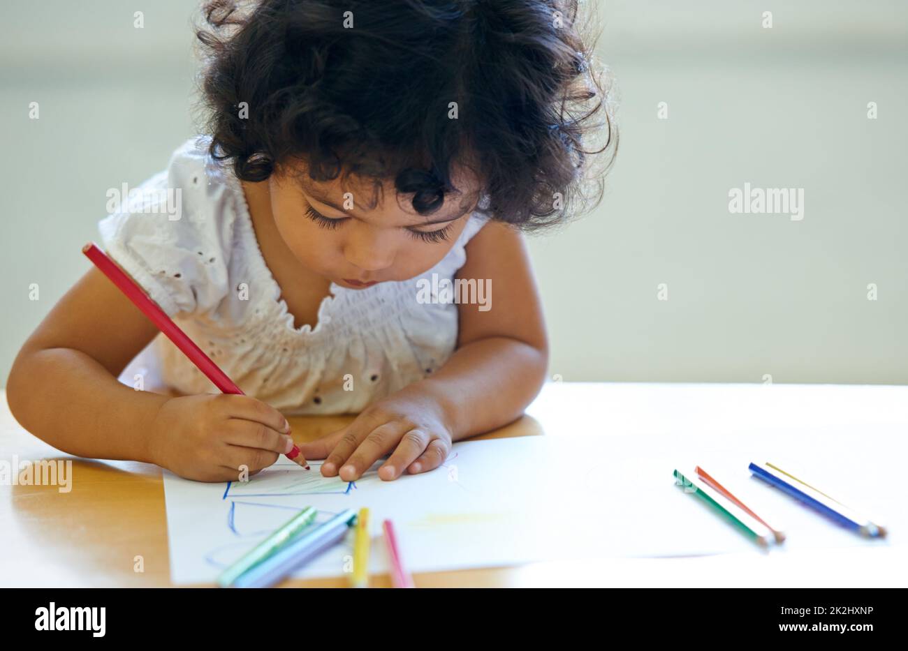 Learning as she grows. Shot of a cute little girl at home Stock Photo ...