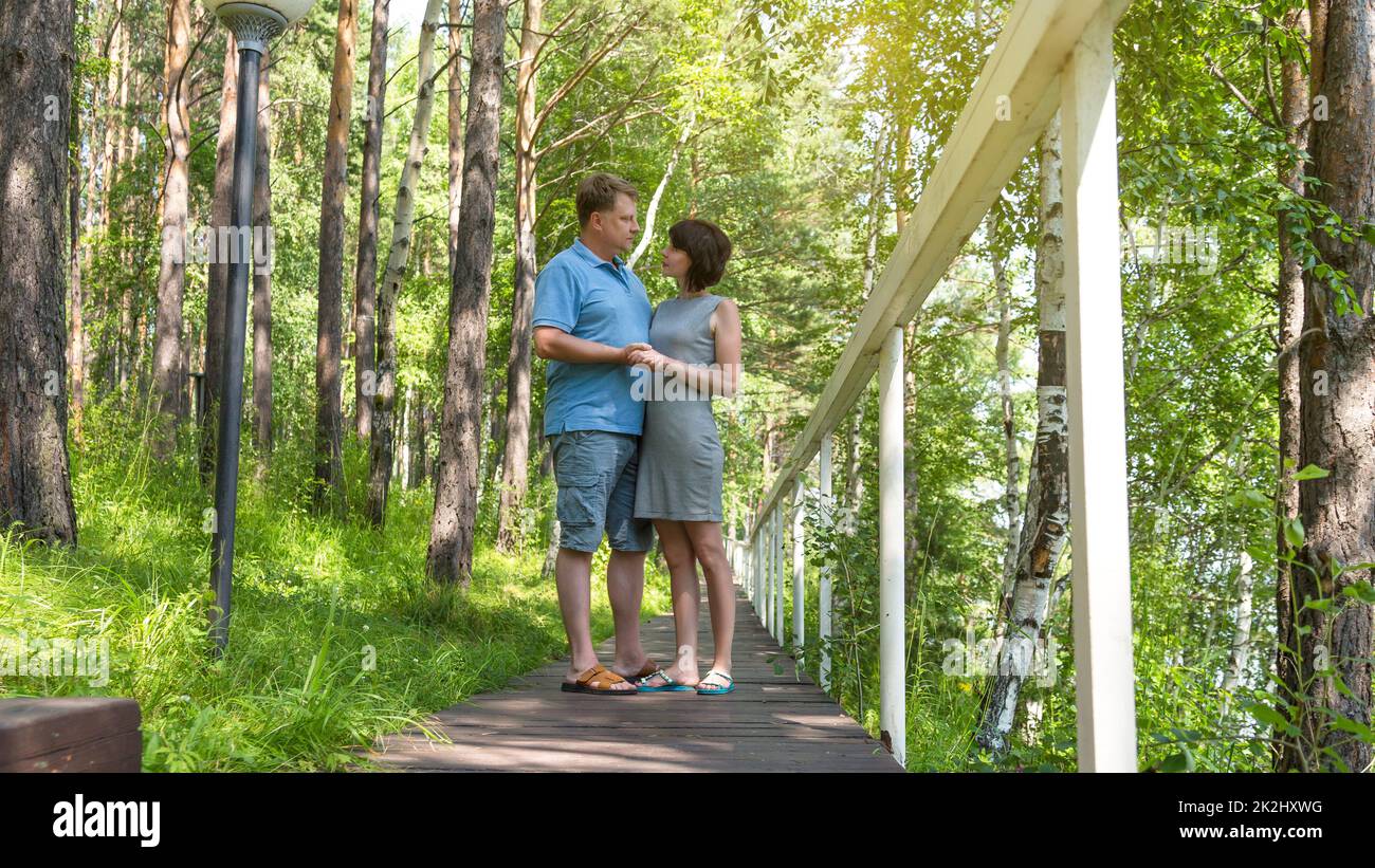 Brunette man woman talk standing hi-res stock photography and images ...