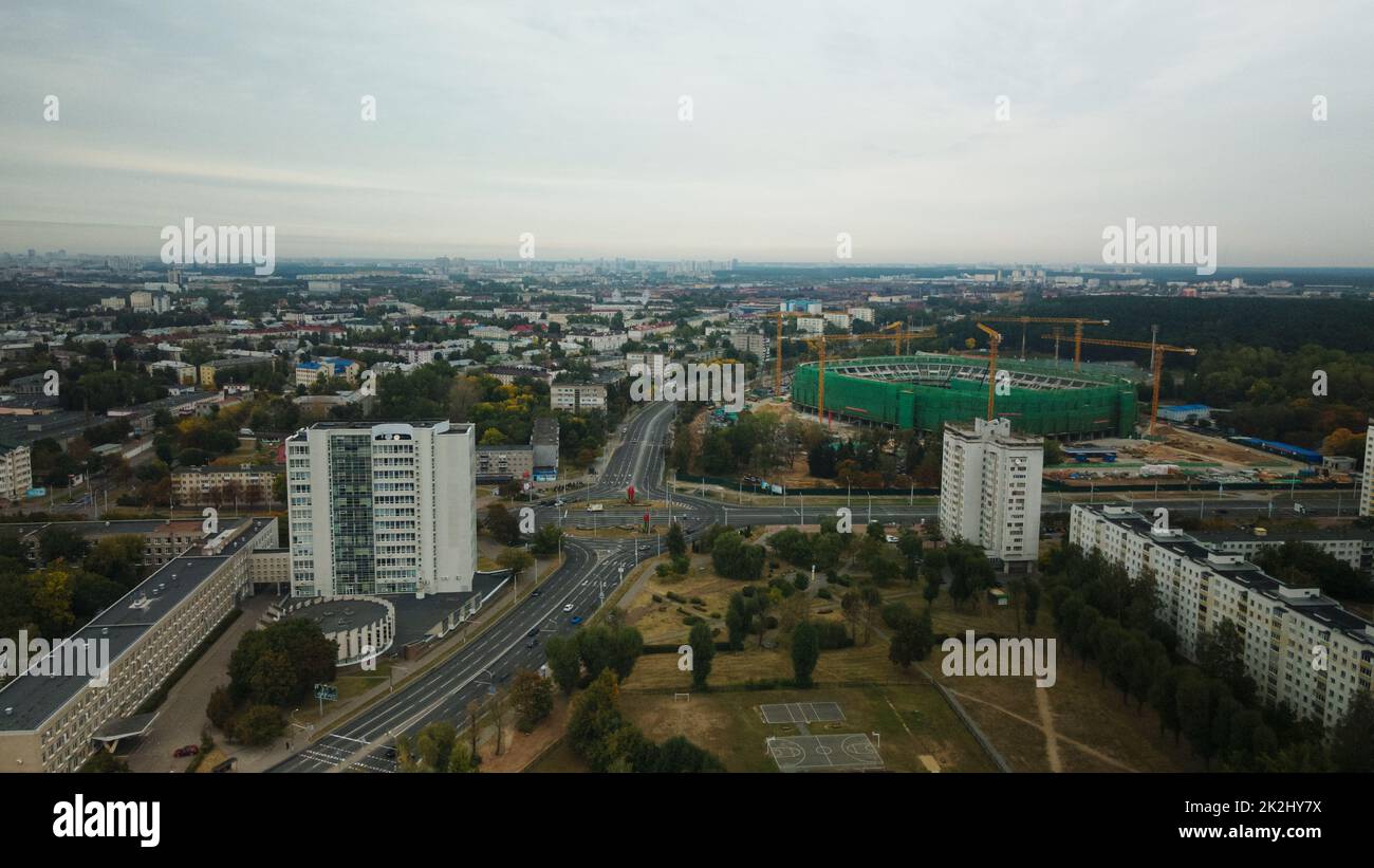 Building a stadium in a big city. Construction site among urban areas ...