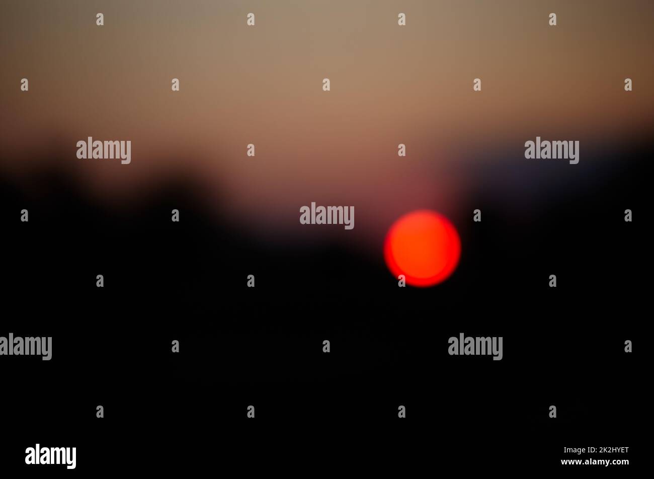 Blurry sunset background photo. Defocused disk of the setting sun Stock ...