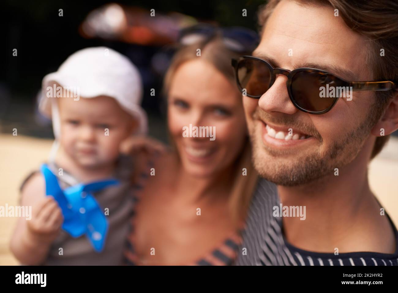 He's a dashing dad. A a smiling handsome man standing with wife and ...