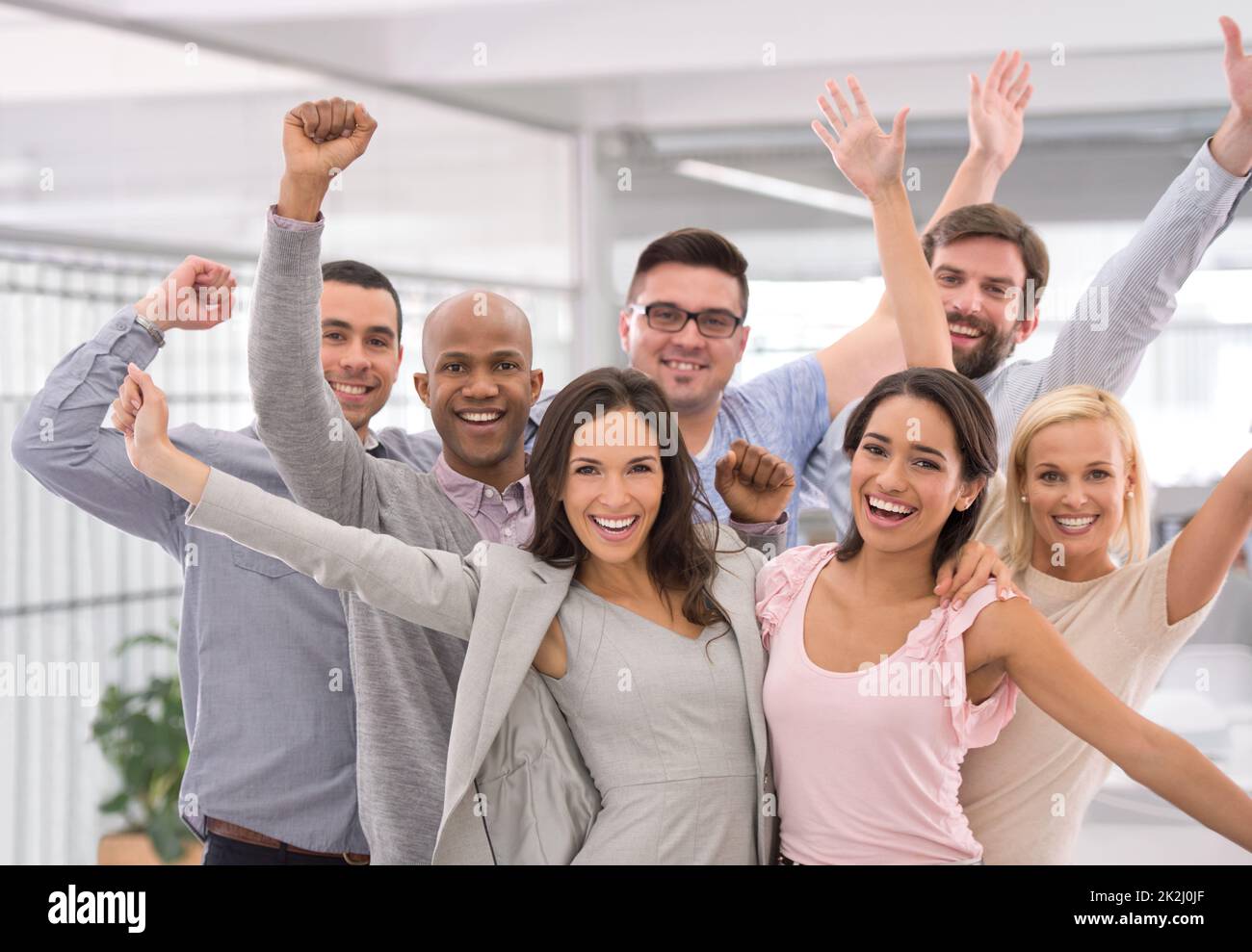 Let's celebrate success. Cropped shot of a group of businesspeople ...