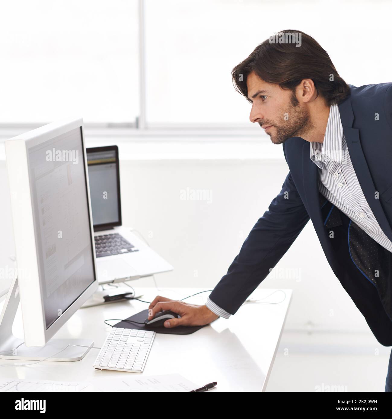 Just one final change.... Shot of a handsome man working on a computer ...