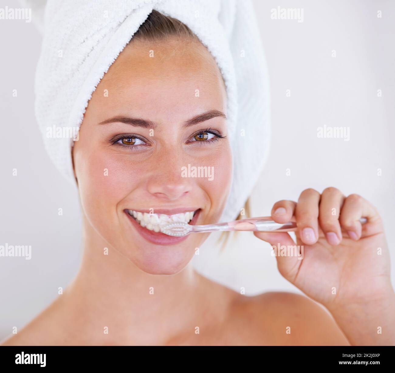 Brushing away all the bad stuff. Close up of a pretty lady brushing her ...