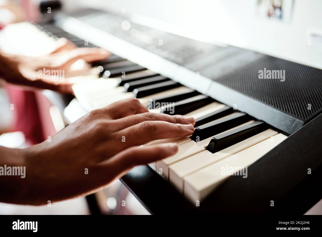 Piano keys unlock the language of the soul. Cropped shot of a woman ...