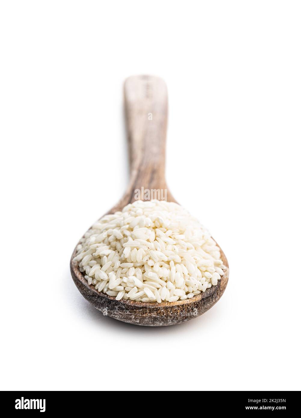 Uncooked Carnaroli risotto rice in wooden spoon isolated on white ...