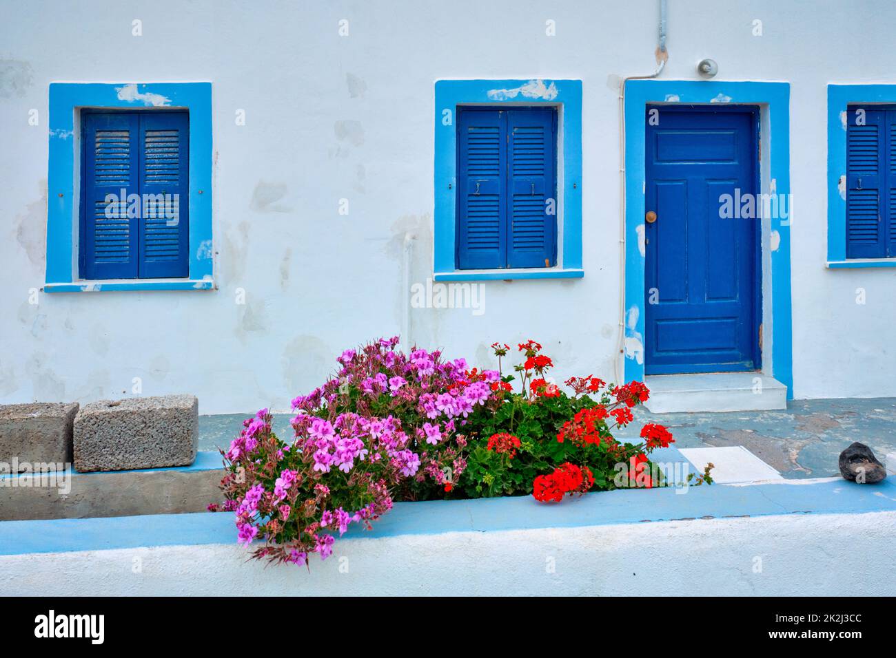 Greek white house with blue door and window blinds Oia village on ...
