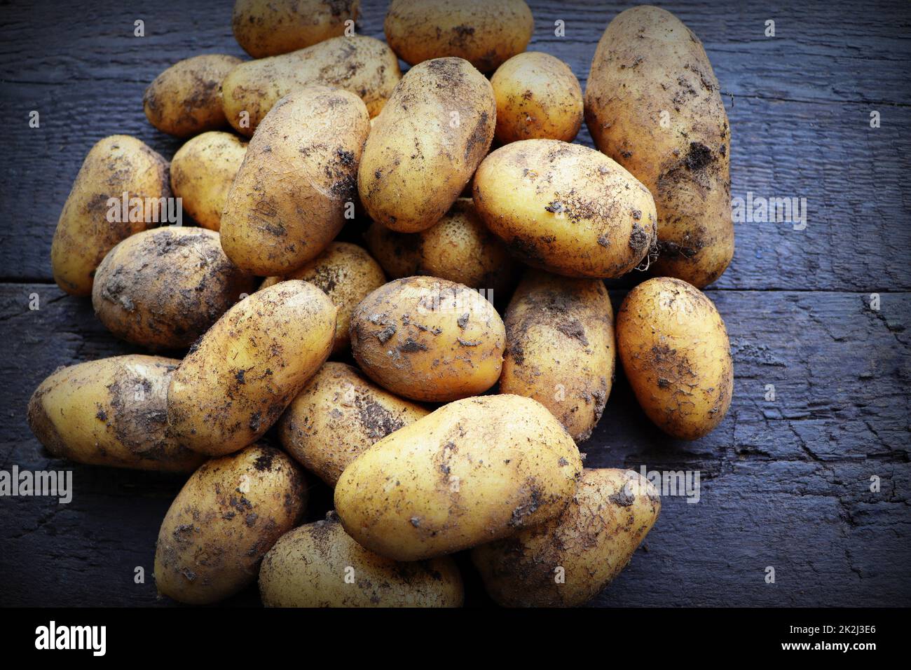 Fresh raw potatoes on a wooden rustic background Stock Photo - Alamy
