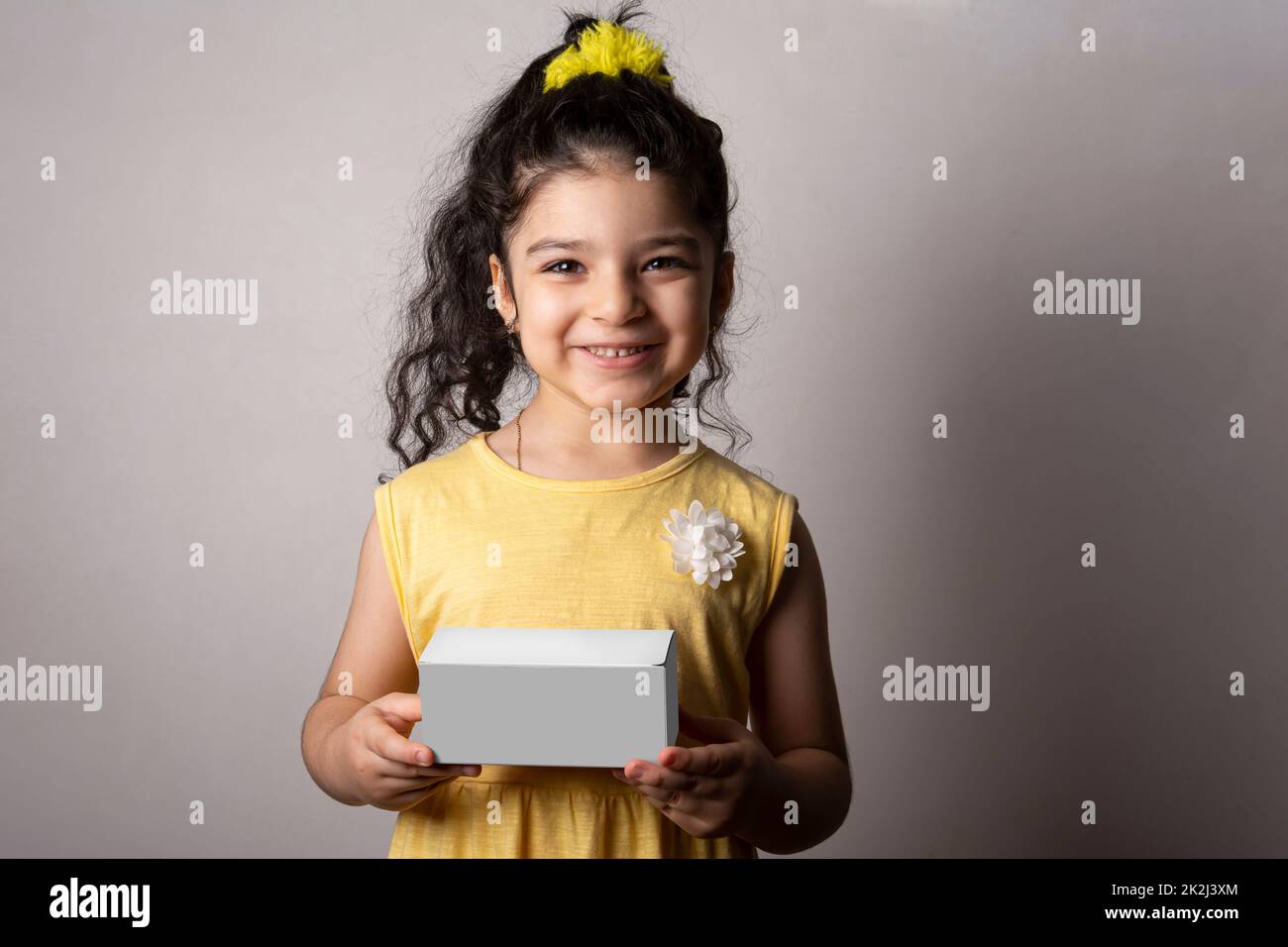 Little girl holding a box in hand mock-up series 421 Stock Photo - Alamy