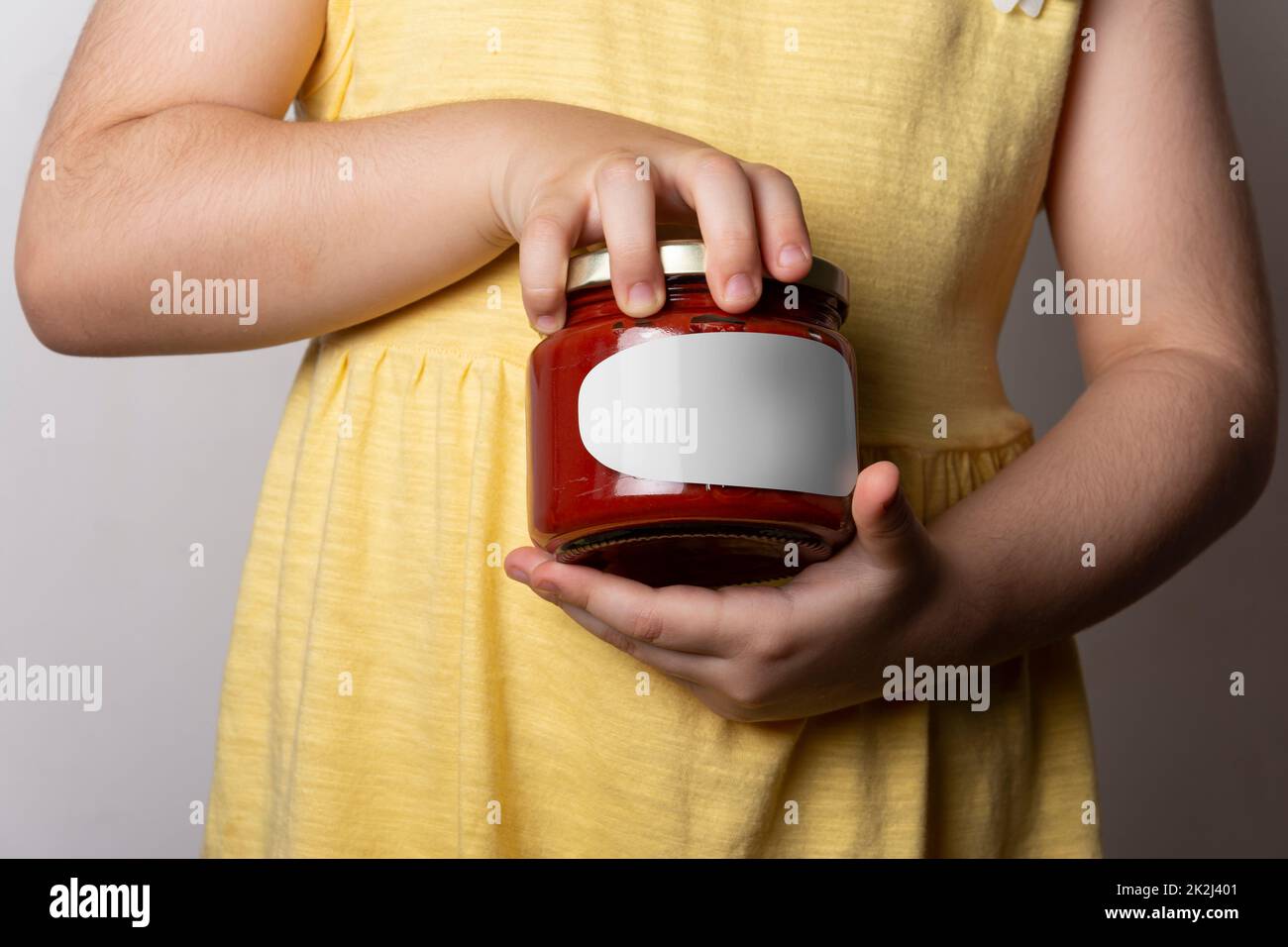Little girl opening a tomato paste jar cap by hands mock-up series ...