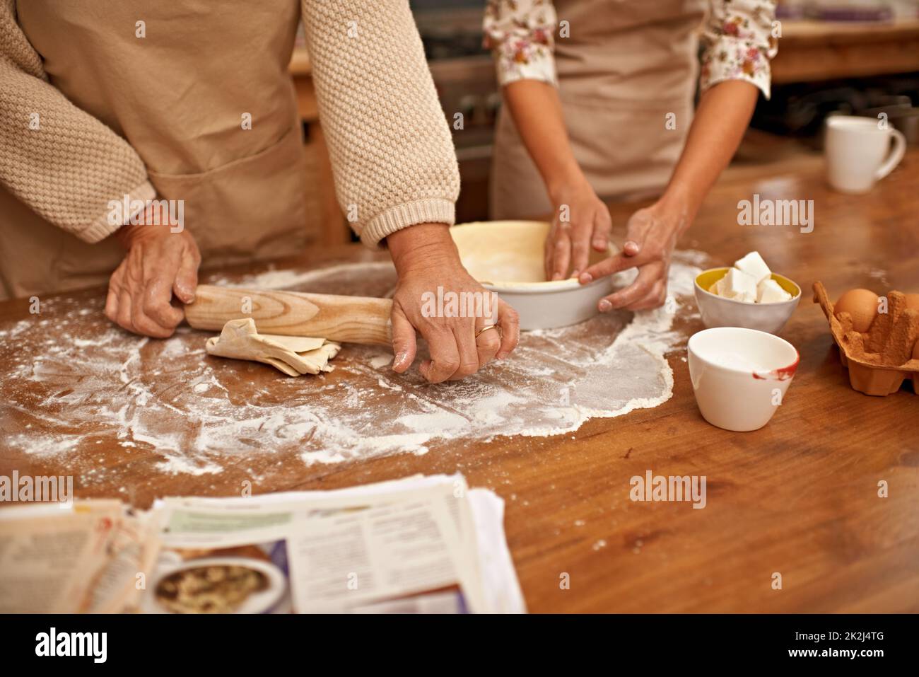 Made with love...A cropped view of hands working the dough while baking ...