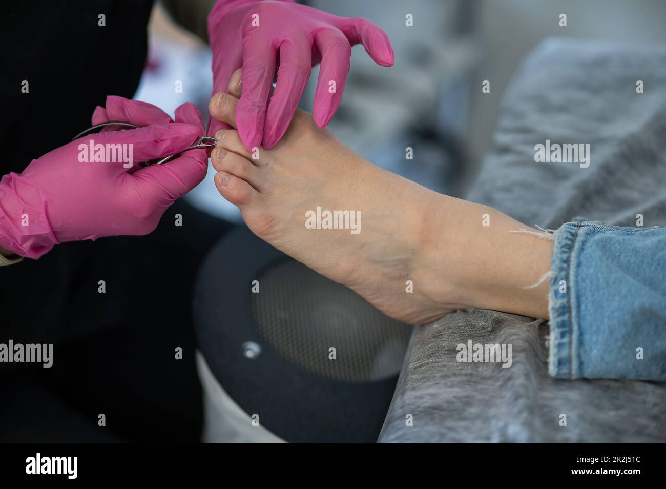 Podiatrist makes a pedicure to a client. The master conducts hygiene of ...