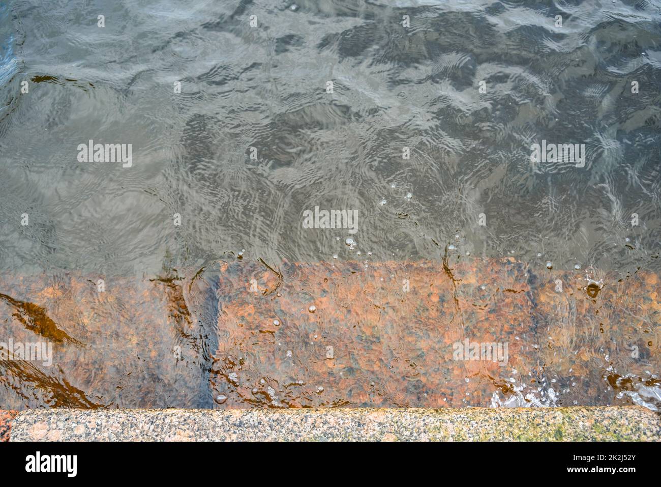 Rusty step visible through shallow transparent river water Stock Photo ...