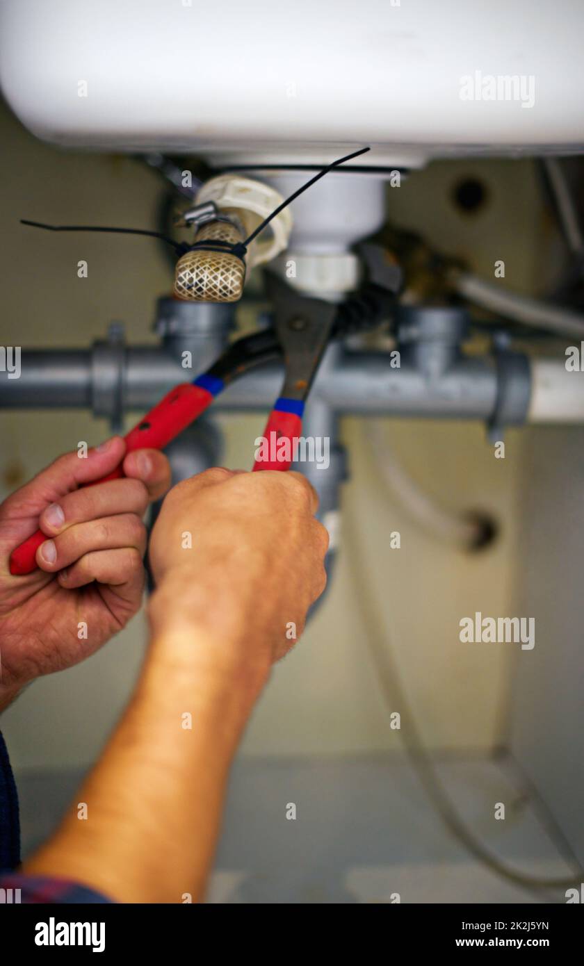 Righty tighty - lefty loosey. an unrecognizable plumber fixing a pipe ...