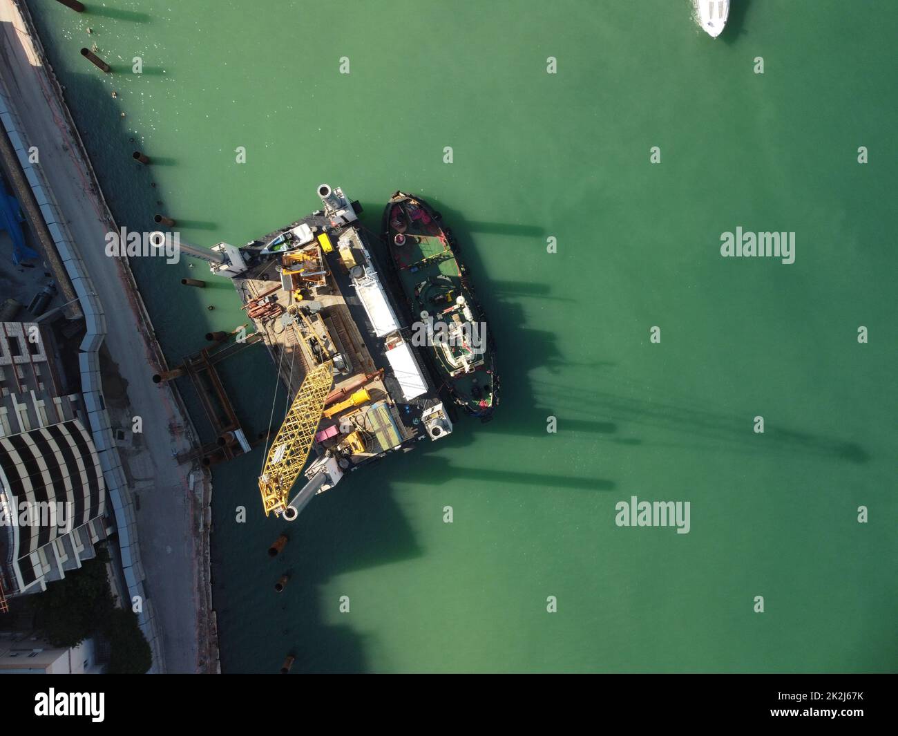 Floating crane dredging barges working on the construction of a marina. Aerial top view Stock ...
