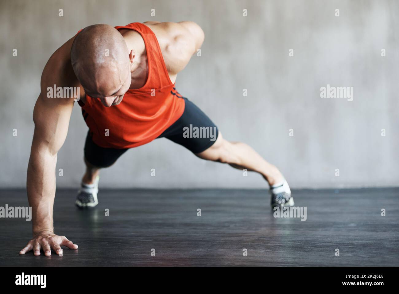Stepping up his fitness routine. Shot of a man working out at the gym ...