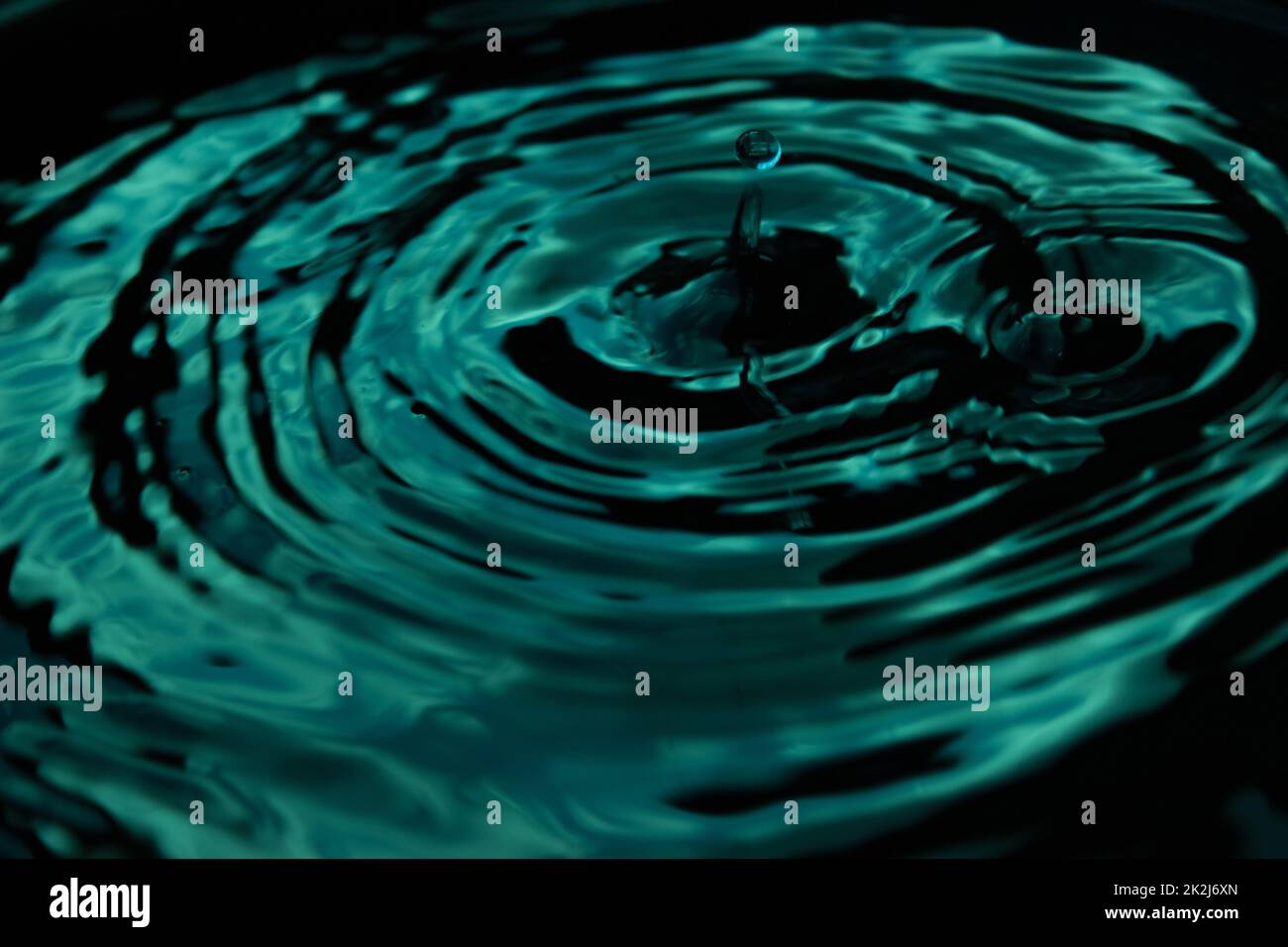 Two drops of water jumping Stock Photo - Alamy