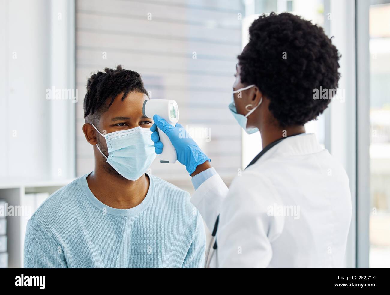 I need to take your temperature first. Shot of a female doctor taking ...