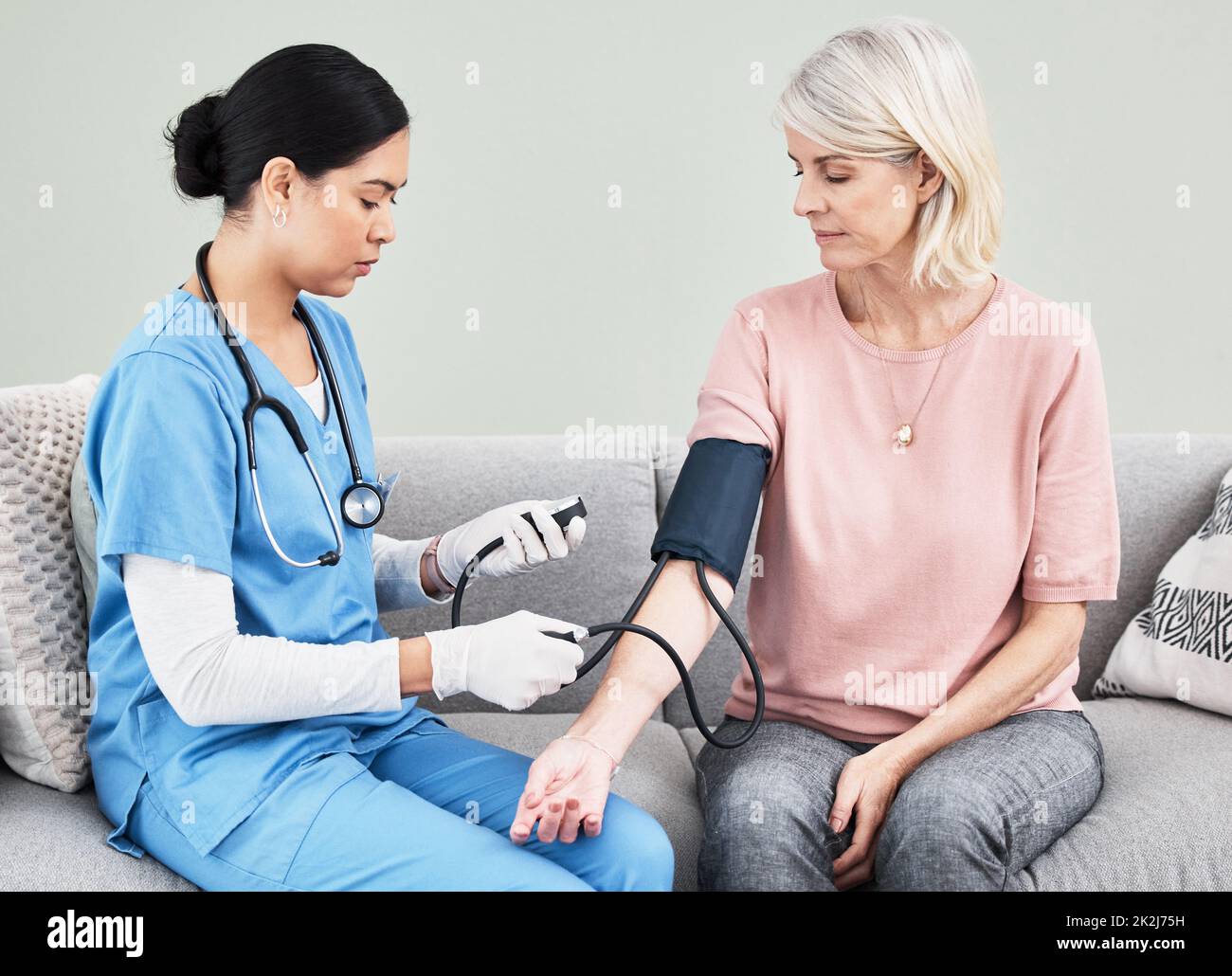 Nurse checking blood pressure hi-res stock photography and images - Alamy