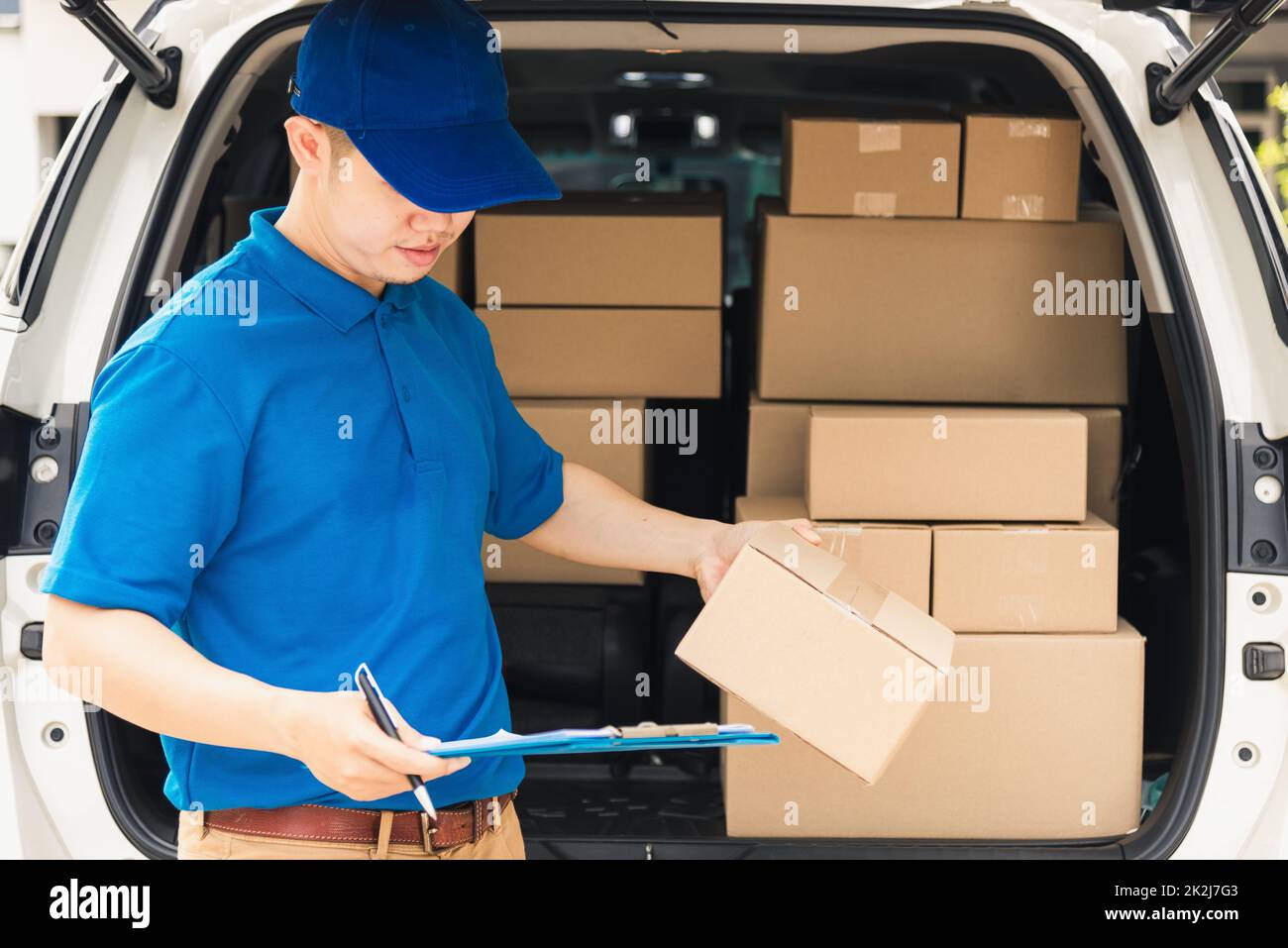 man courier in uniform hold documents clipboard checking list parcel ...