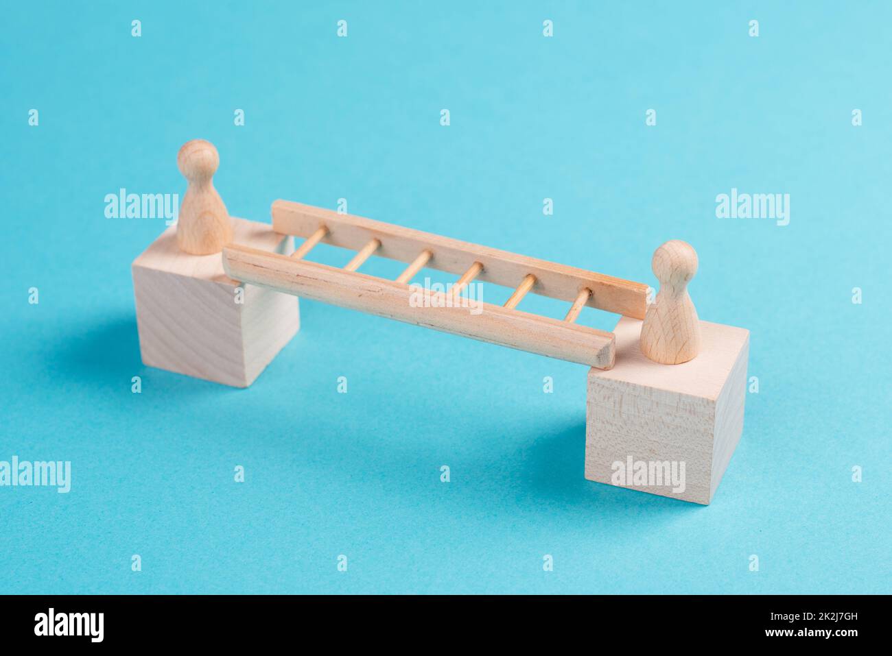 Two people connect by a ladder, buliding a bridge between men ...