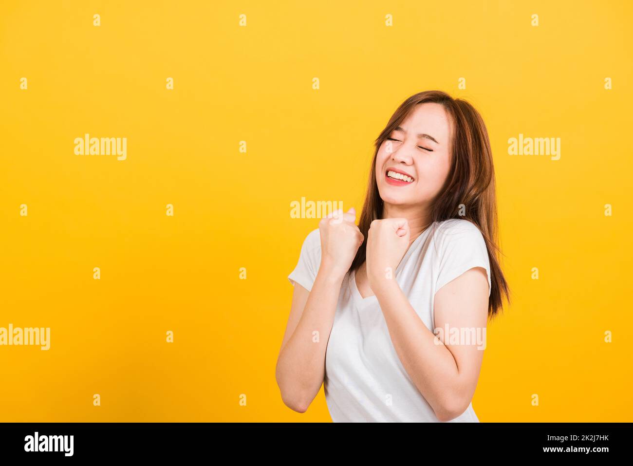 woman teen standing wear t-shirt makes raised fists up celebrating her ...