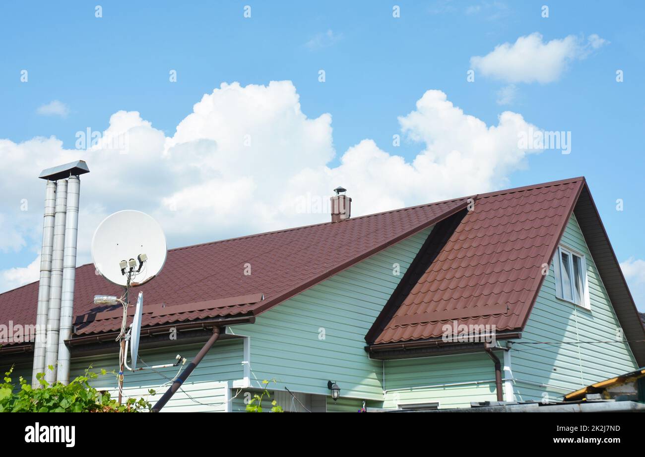 Valley and gable roofing construction with attic windows, rain gutter ...